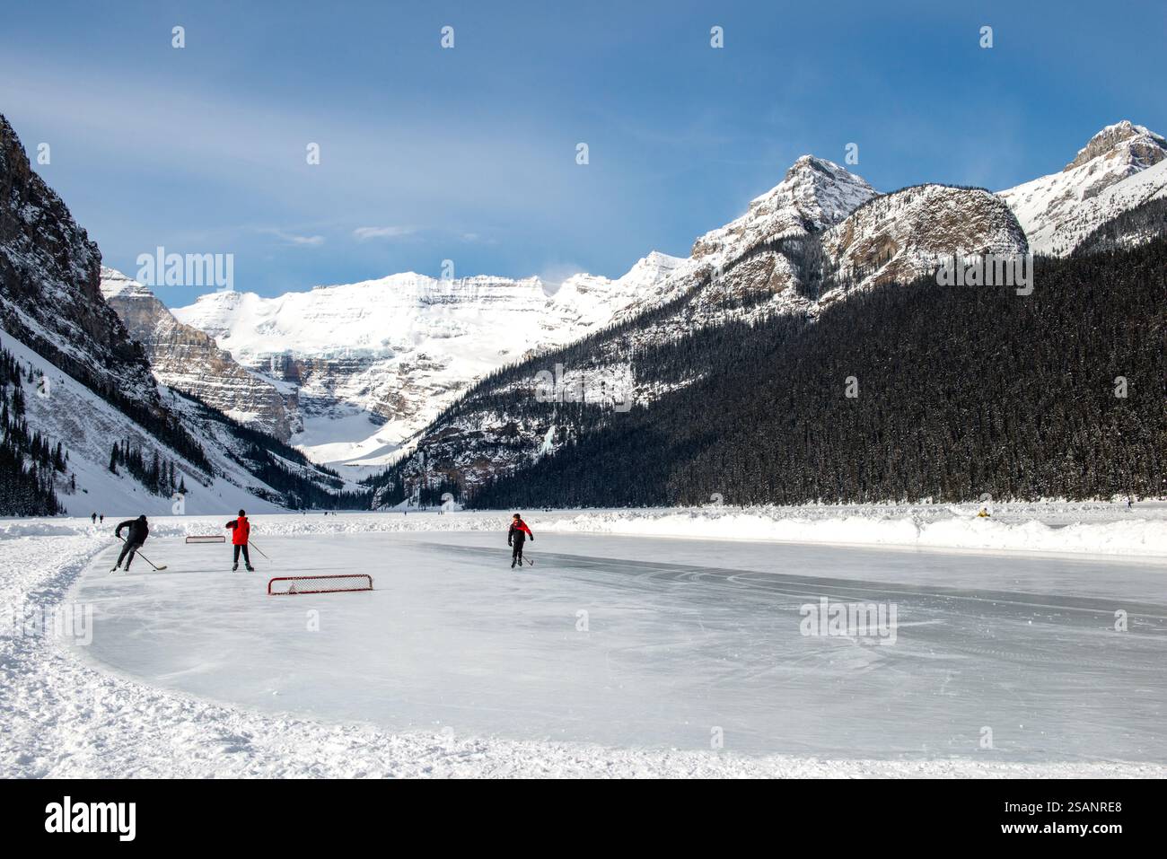 People playing ice hockey on iconic frozen Lake Louise in Banff ...