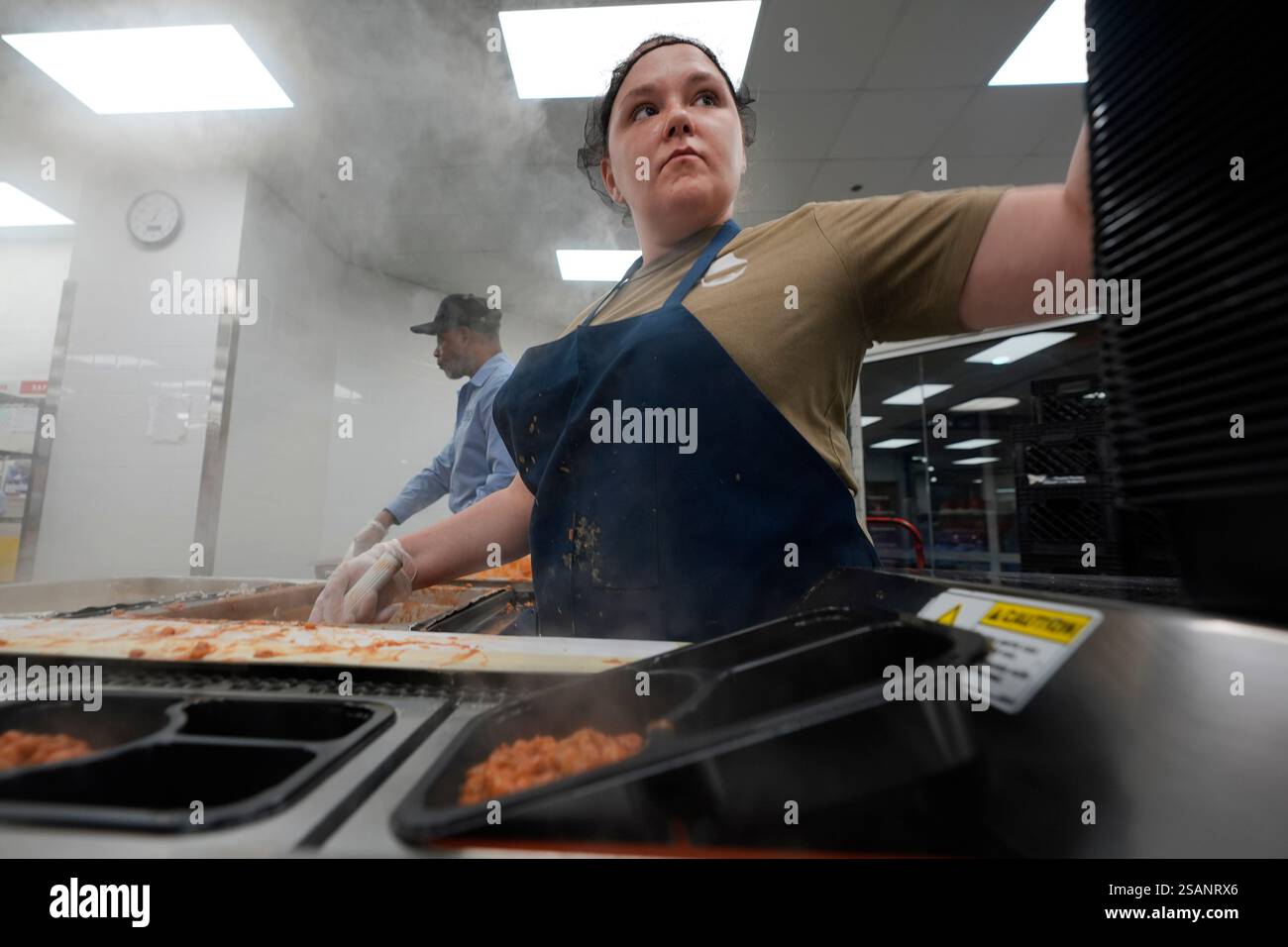 Amanda Peters packs food for delivery to the elderly by Meals On Wheels ...