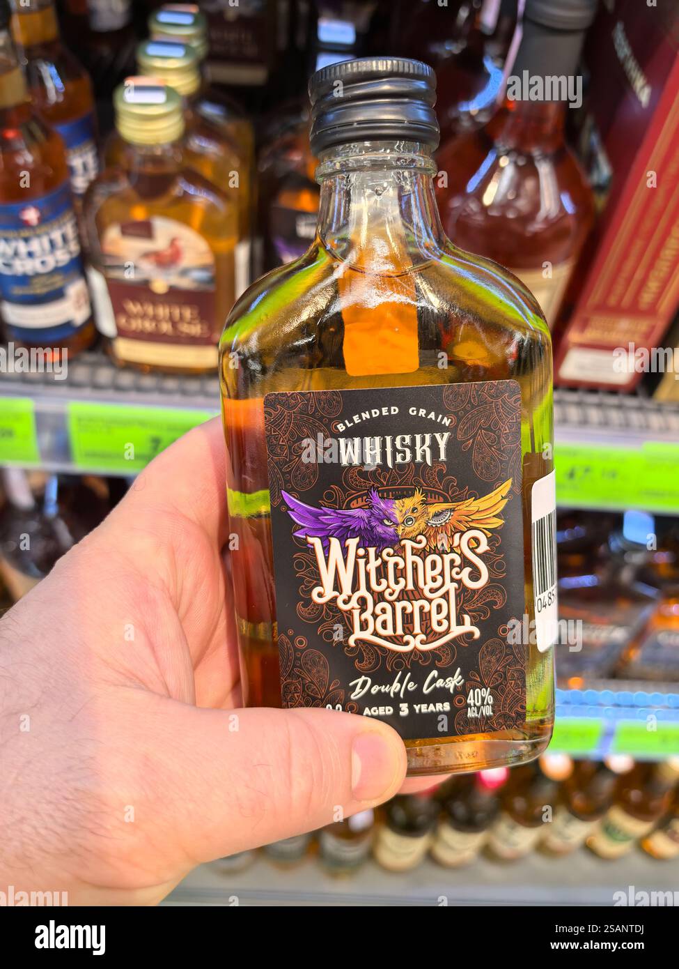 Bobruisk, Belarus - 26 January 2025: A hand holds a distinctive whisky ...