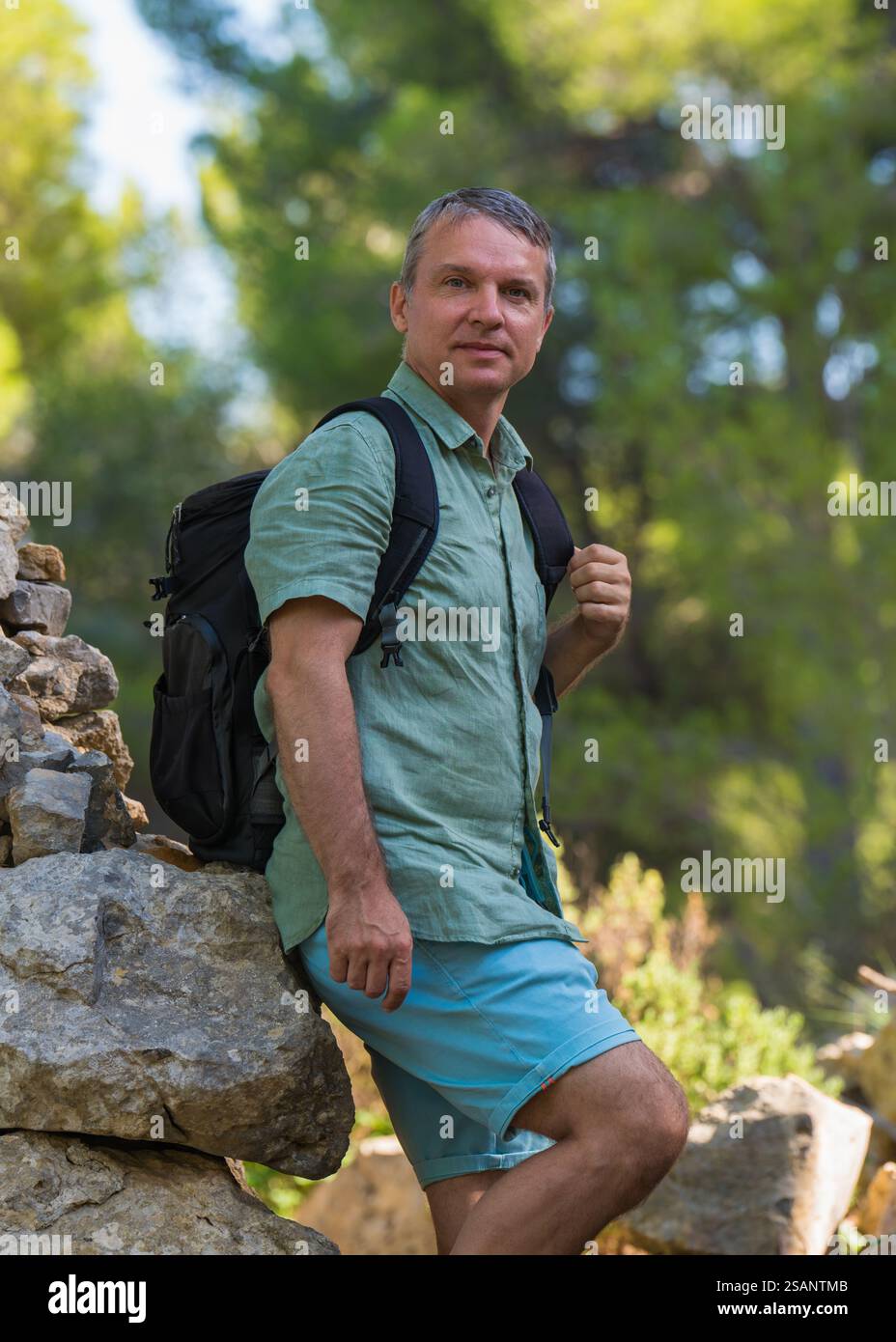 Middle aged man with backpack traveling through scenic areas Mallorca ...