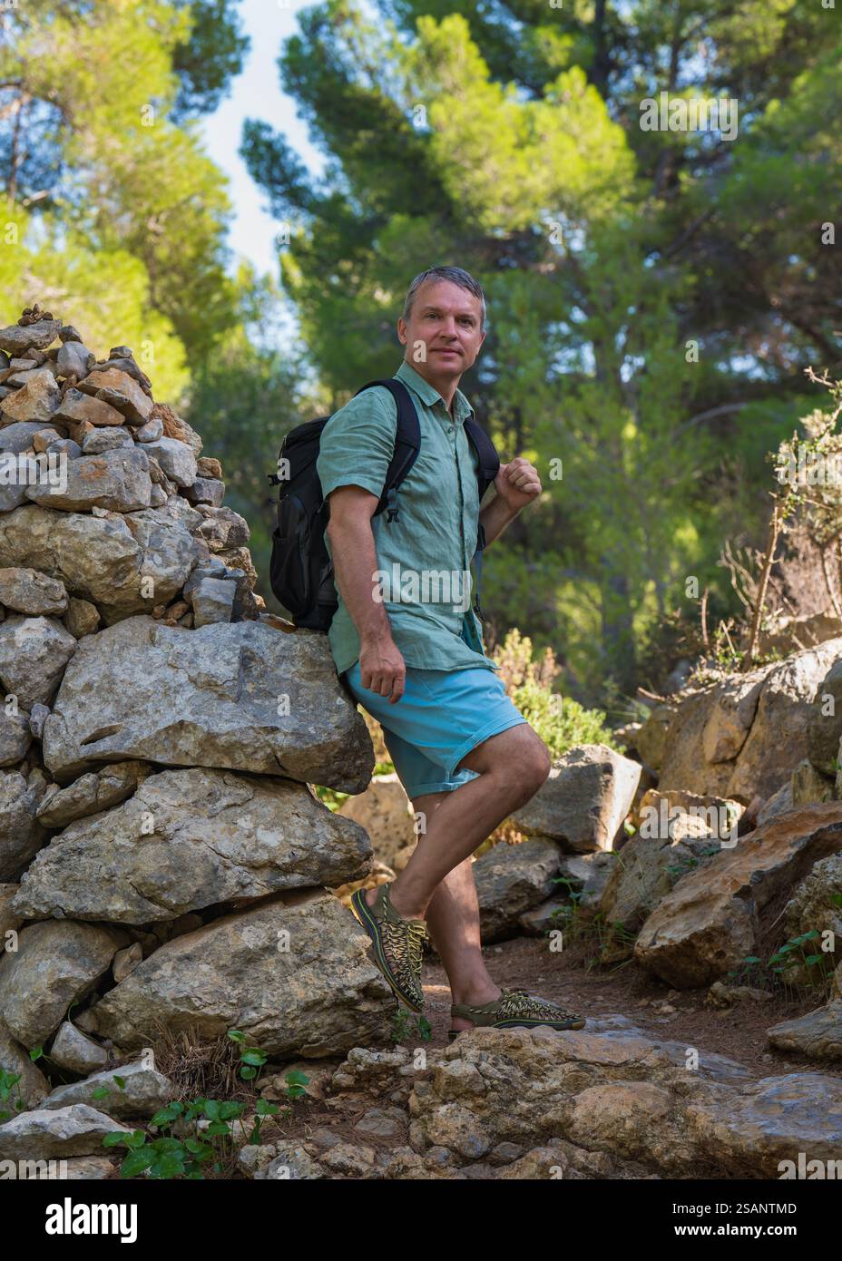 Middle aged man with backpack traveling through scenic areas Mallorca ...