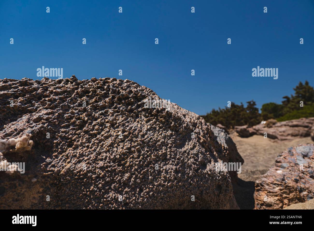 Detail of effects oh physical weathering on a rock at sandy beach near ...