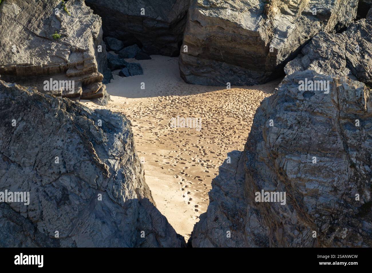 Footprints in the sand leading along a beach, surrounded by striking ...