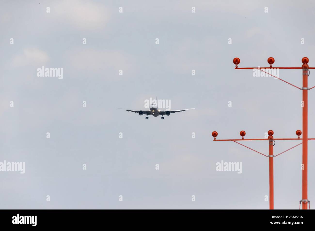 A commercial aircraft descends toward a major international airport ...