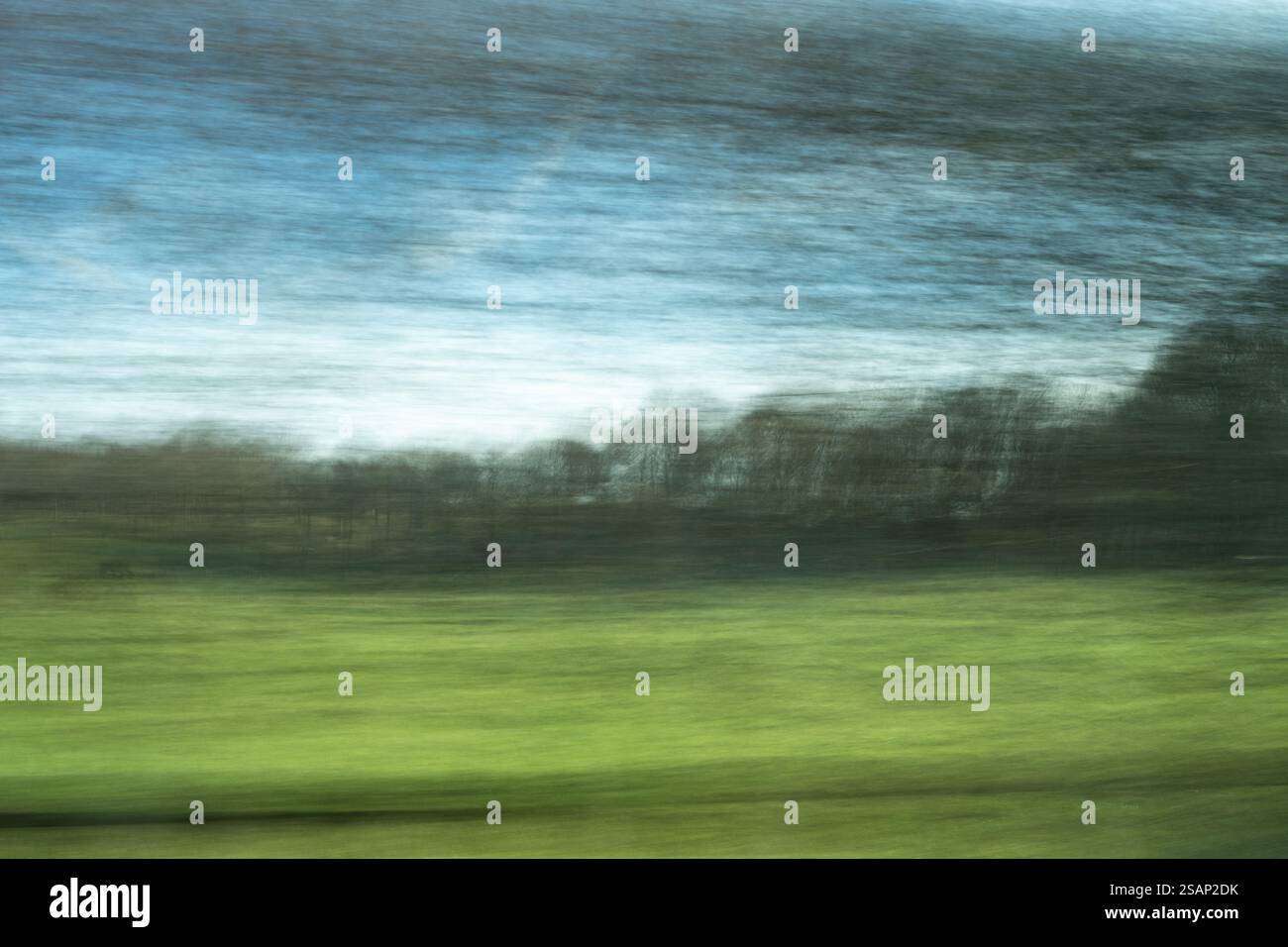 Driving through countryside in winter concept - blurred trees seen ...