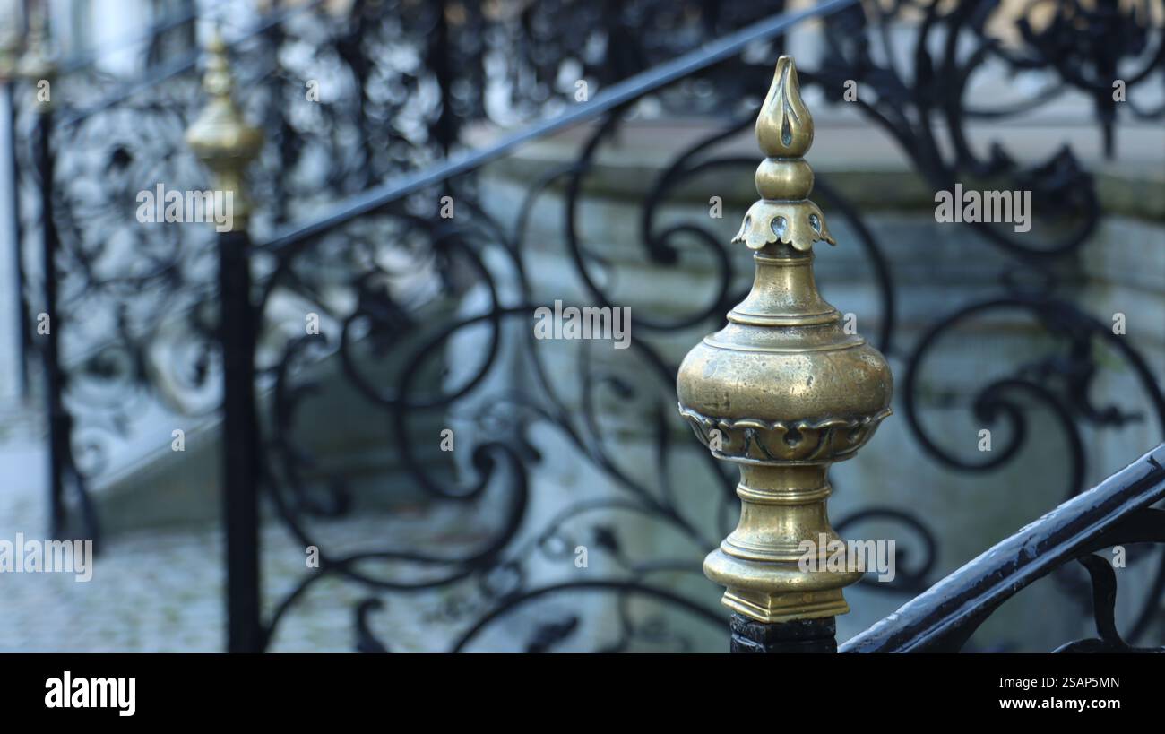 Details of an ornate brass railing on a historic staircase in a ...
