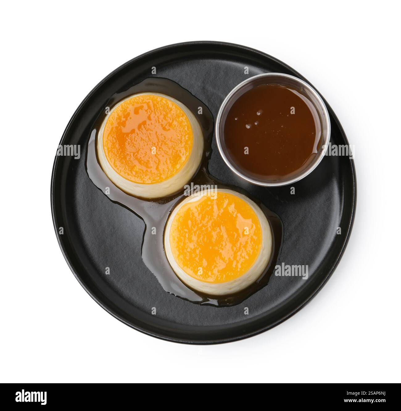 Tasty puddings with caramel sauce isolated on white, top view Stock ...