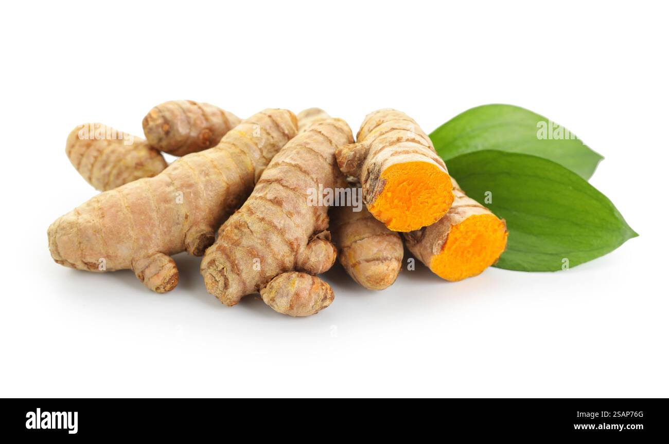 Raw turmeric roots and green leaves isolated on white Stock Photo - Alamy