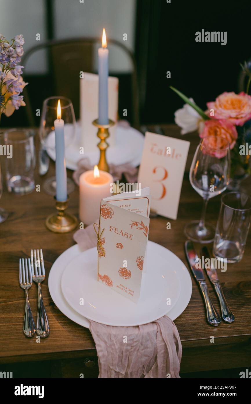 A beautifully arranged dining table features a floral centerpiece, soft ...