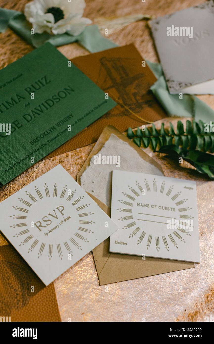 A carefully arranged collection of wedding invitation cards, including ...