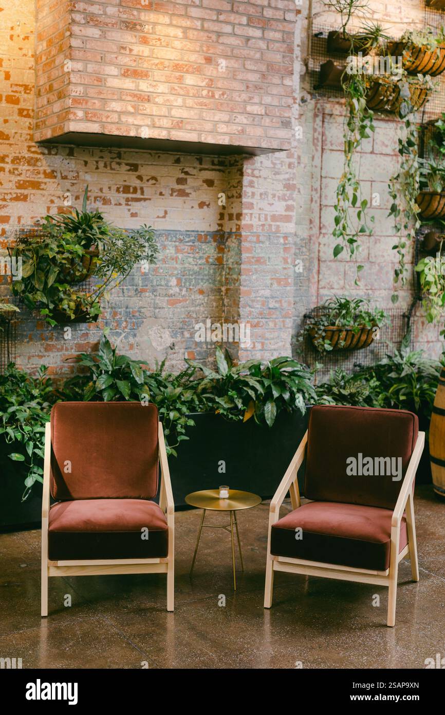 Two modern chairs sit beside a small metal table, surrounded by vibrant ...