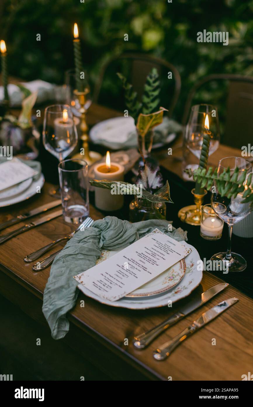 A beautifully arranged outdoor dining table showcases elegant dishware ...
