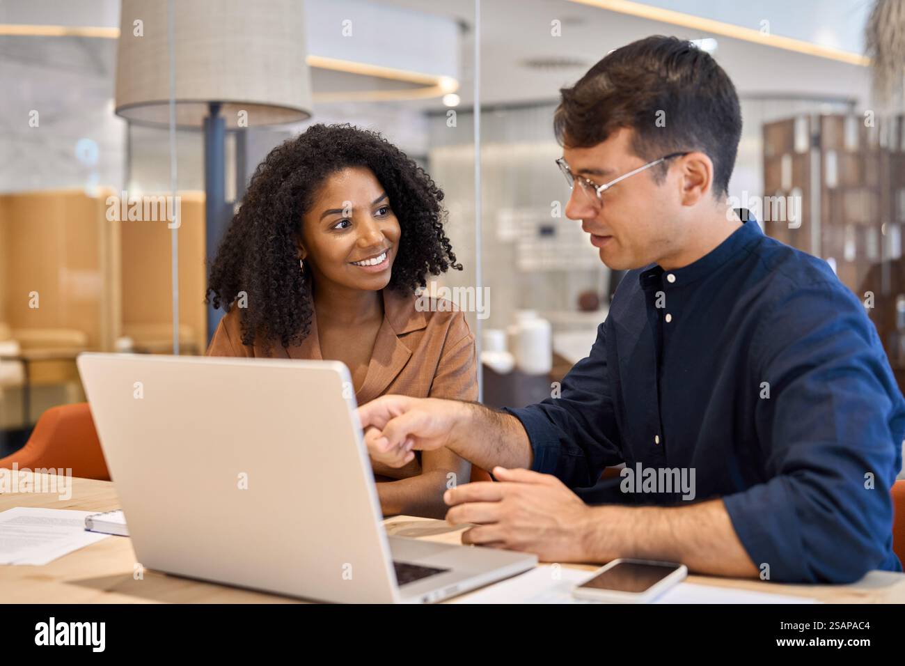 Diverse team professional employees working together on computer in ...