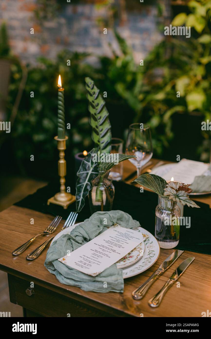 An intimate dining table is adorned with a menu, elegant cutlery, and a ...