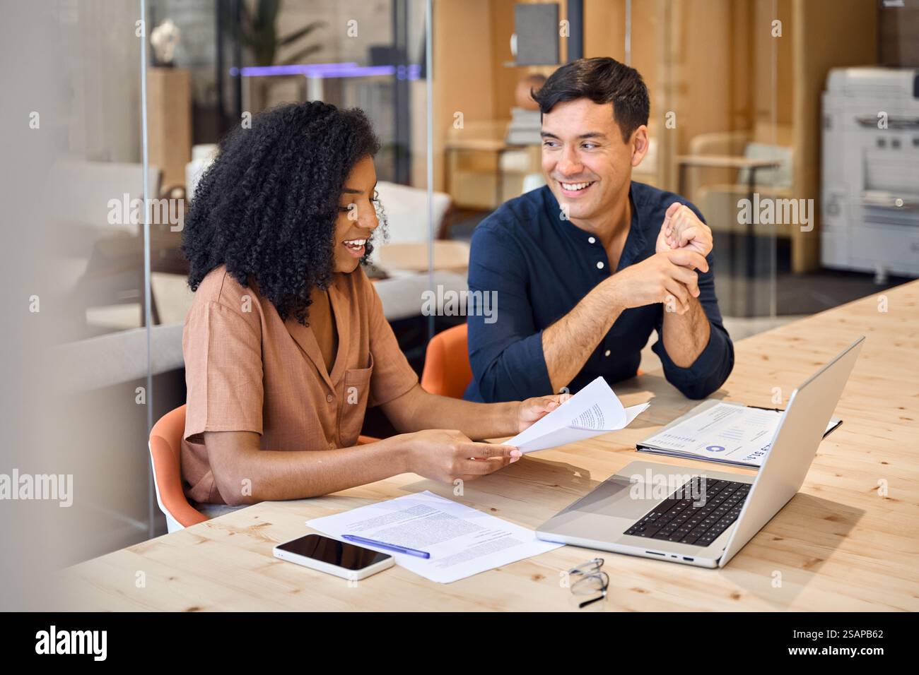 Happy diverse designers using laptop hi-res stock photography and ...