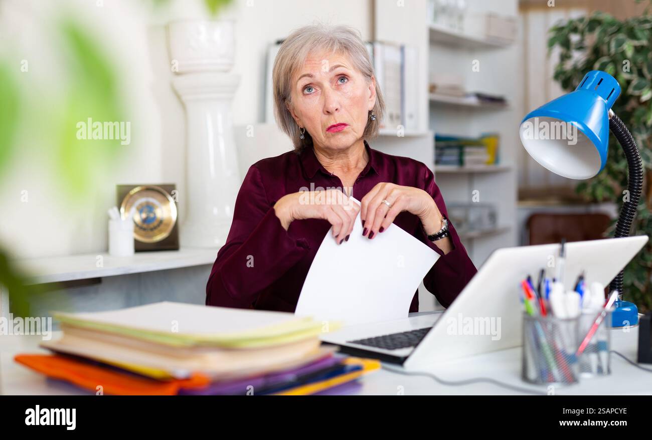 Stressed mature woman working in office Stock Photo - Alamy