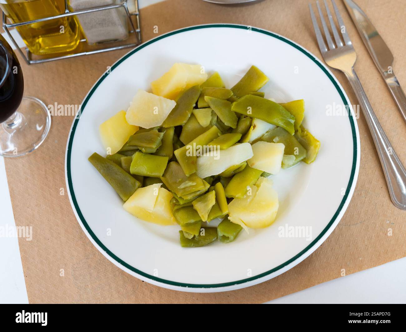 Plate contains light side dish of stewed vegetables - potatoes, green ...