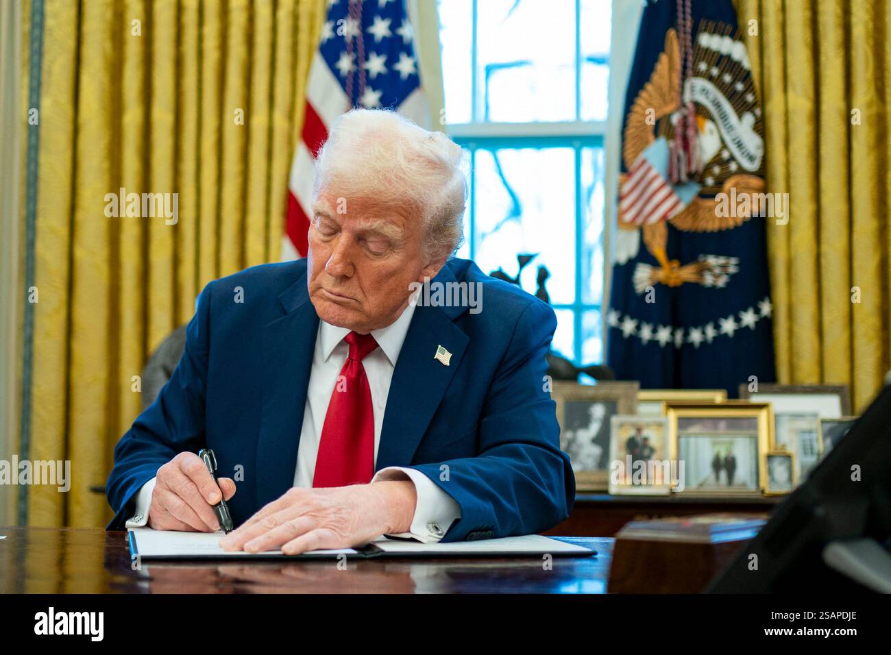 Washington, United States. 30th Jan, 2025. President Donald Trump signs ...