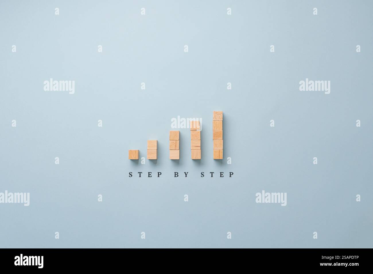 Wooden blocks arranged in ascending order represent progress and ...