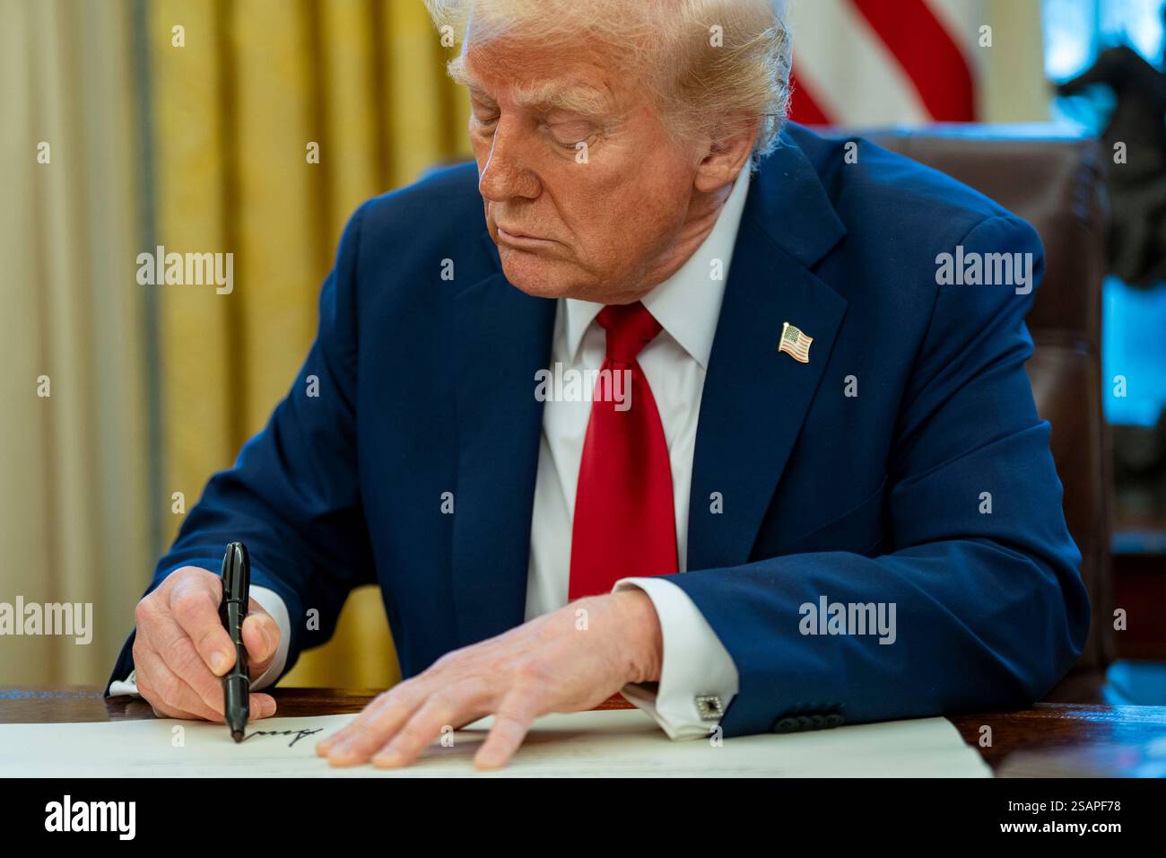 President Donald Trump signs two executive orders in the Oval Office of ...