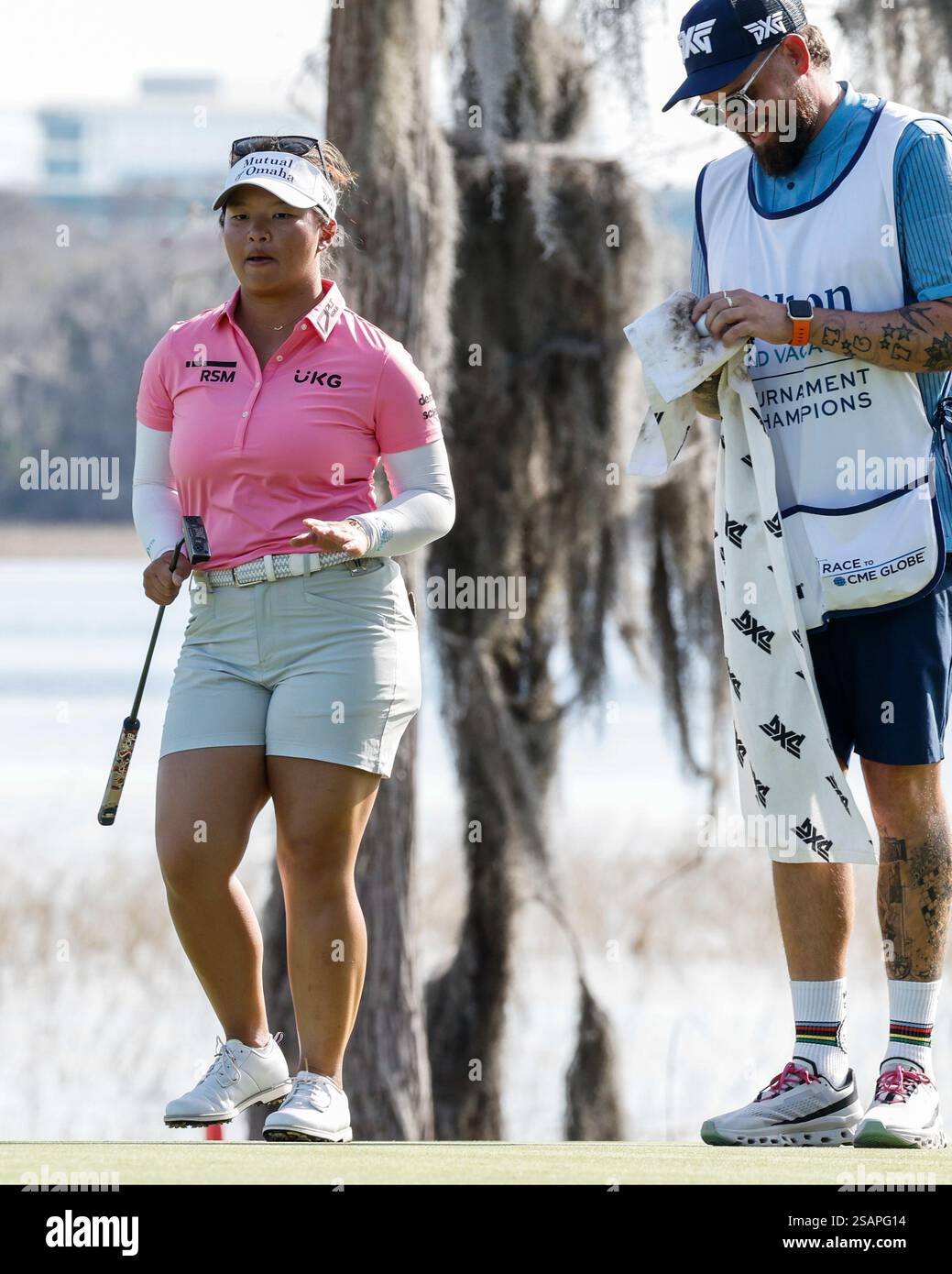 Megan Khang, left, dances on the 18th green before putting during the ...