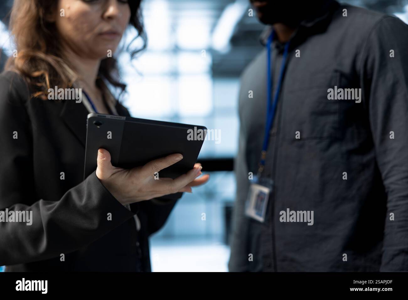 Teamworking colleagues in data center using tablet, analyzing metrics ... Teamworking colleagues in data center using tablet, analyzing metrics ...