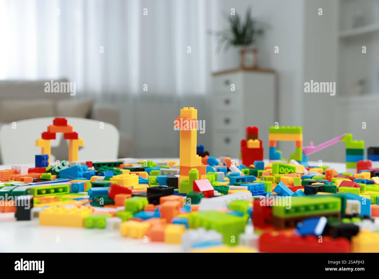 Construction toy. Figures made with building bricks and colorful blocks ...