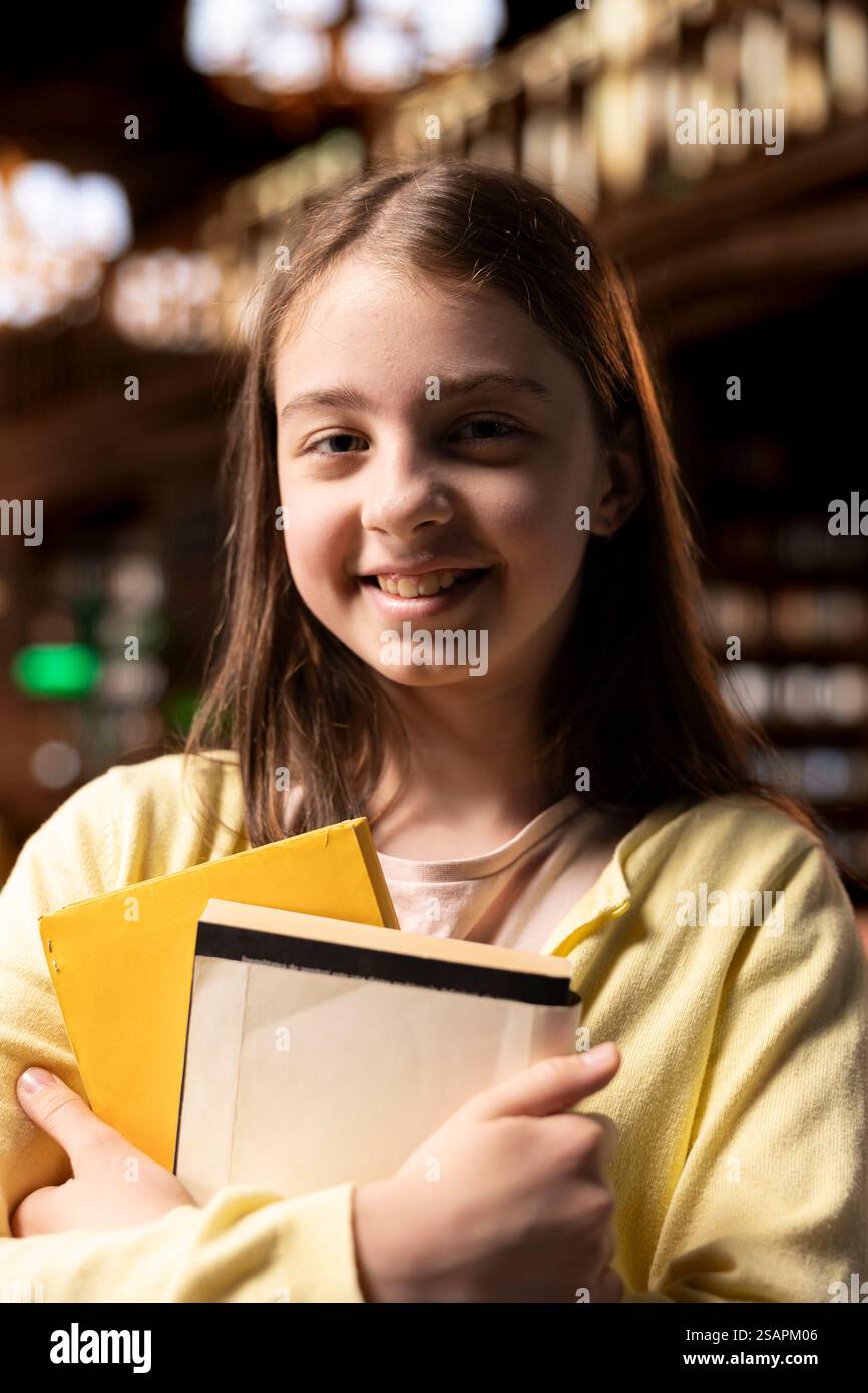 Portrait of caucasian student girl completing her class notes with ...