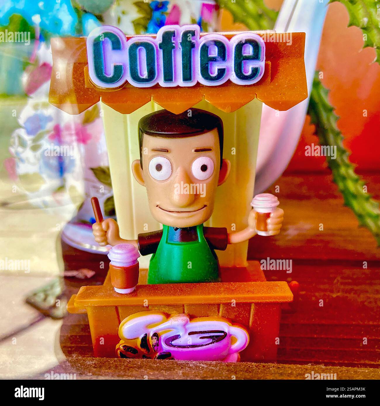Miniature plastic coffee barista in window display Stock Photo - Alamy
