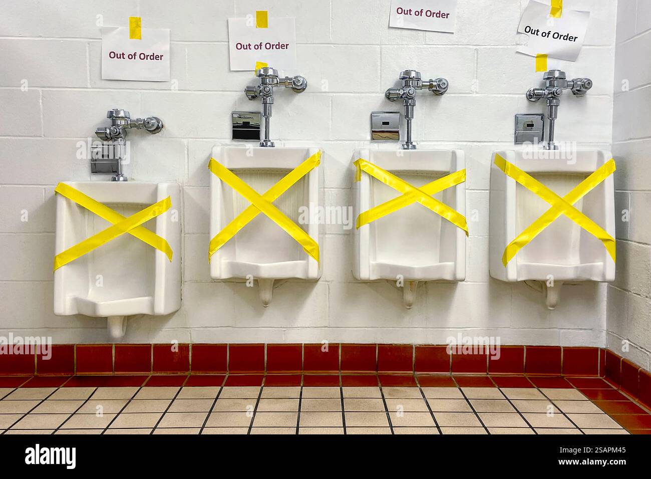 Four out-of-order urinals in public bathroom Stock Photo - Alamy