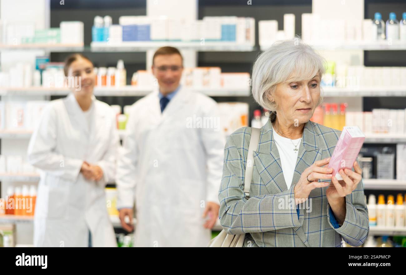 Old woman client choosing convenient care product in box Stock Photo ...
