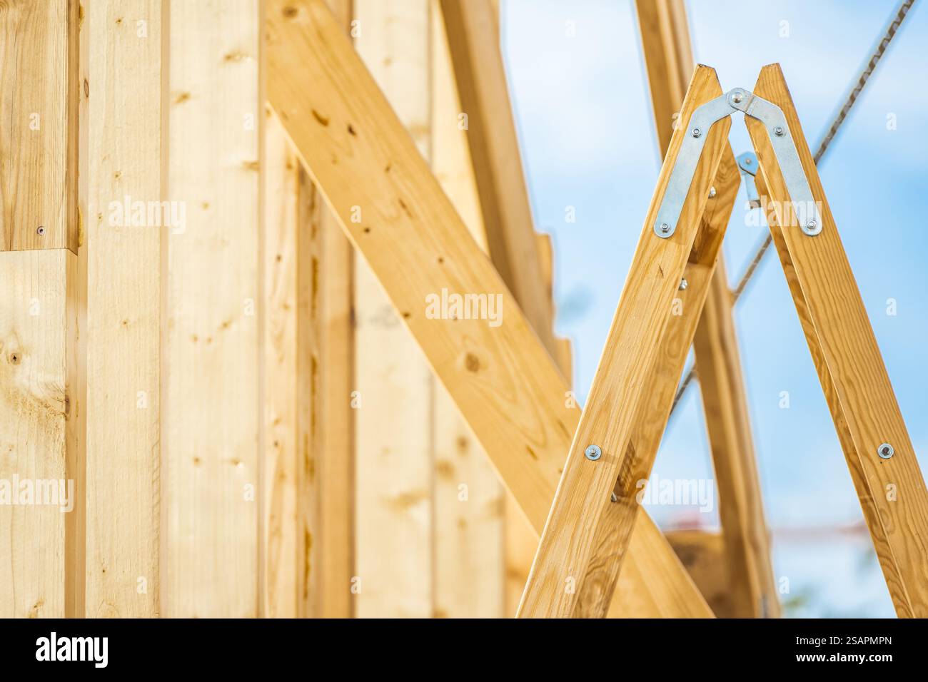 A close view of wooden beams and a ladder used in construction work ...