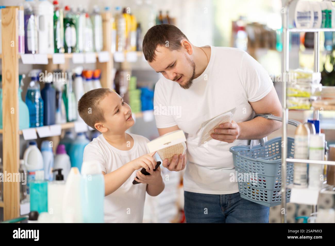 Schoolboy son and dad are choosing mouthwash in store Stock Photo - Alamy