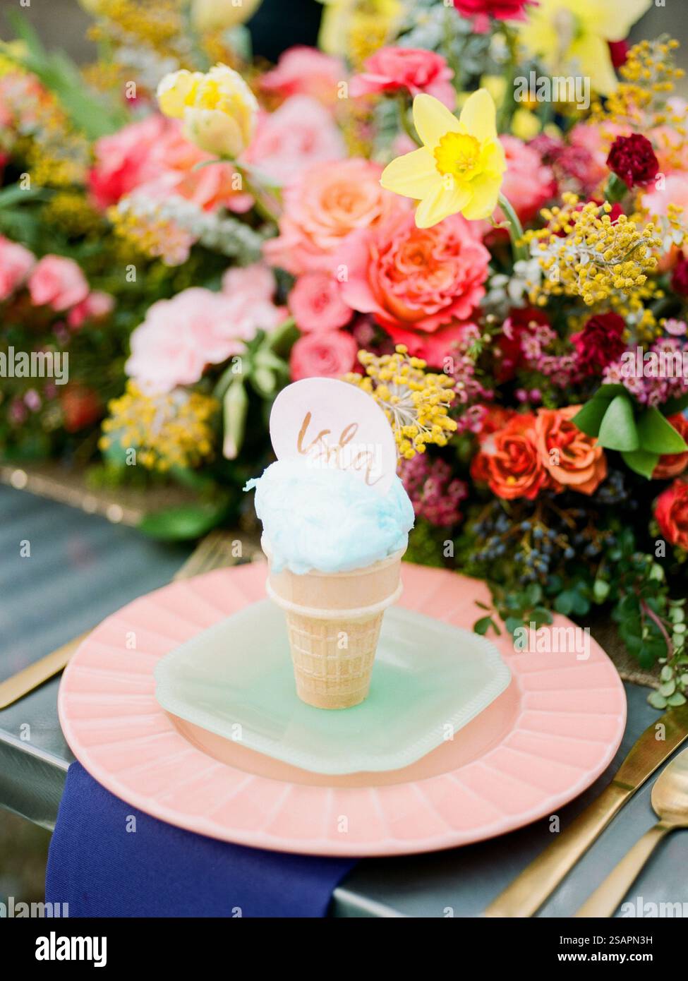 A whimsical ice cream cone topped with blue cotton candy sits on a ...