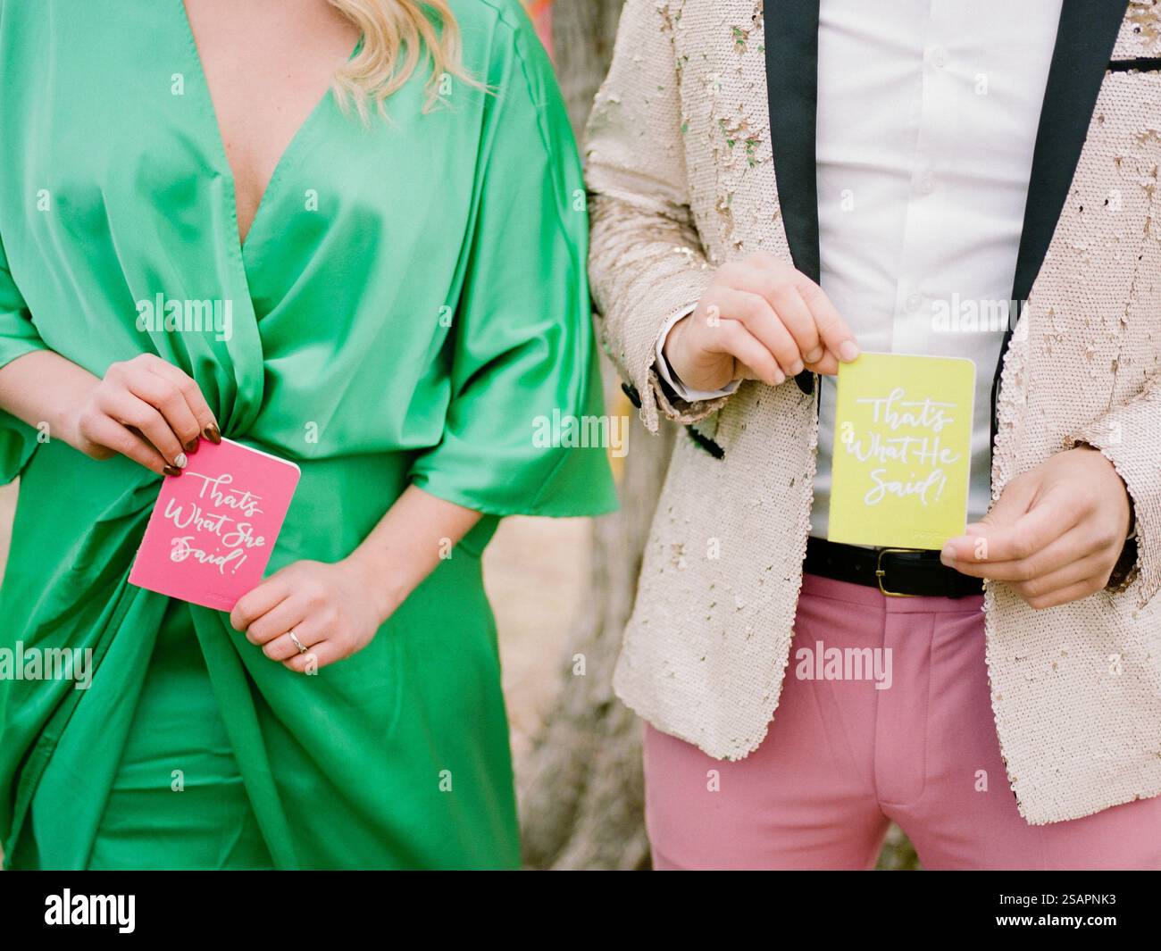 A couple stands together, showcasing bright signs as they celebrate ...