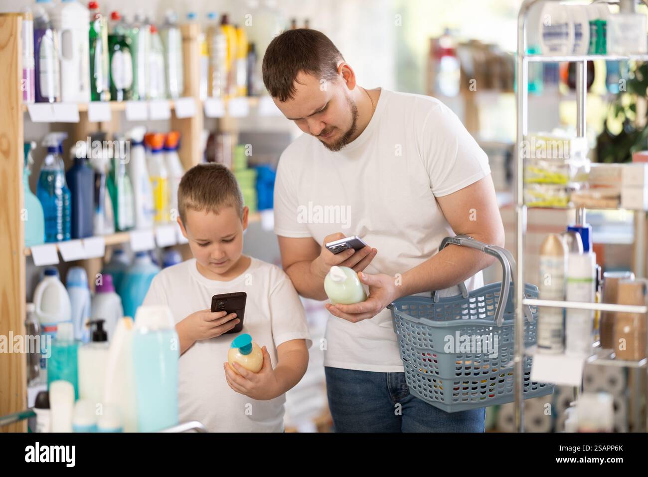 Man and boy scanning qr code for liquid soap Stock Photo - Alamy
