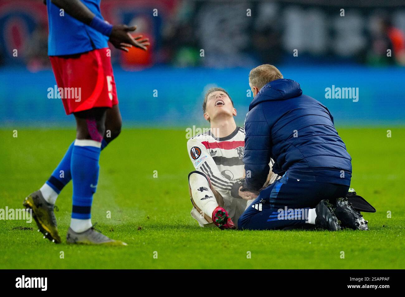 Manchester United's Alejandro Garnacho gets medical treatment after an ...