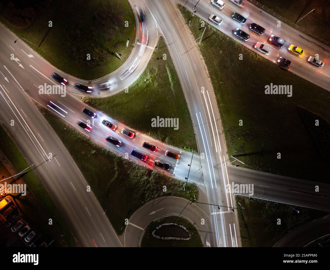 Top down aerial view of a night intersection with a moving traffic ...