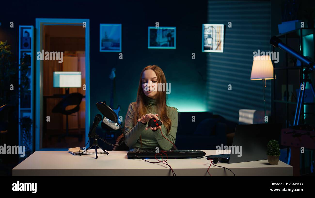 Happy influencer testing keyboard and mouse while doing review in ...