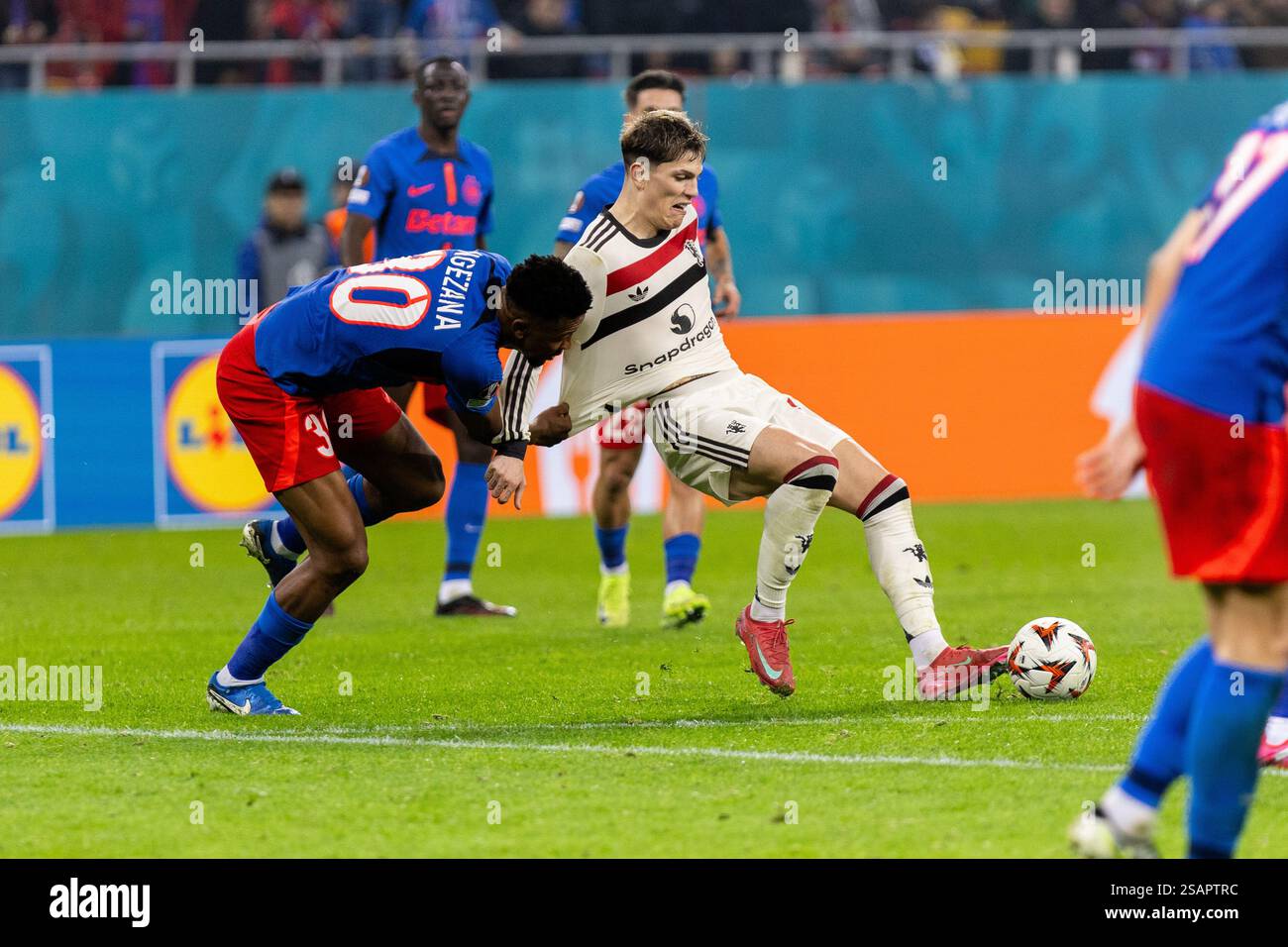 Siyabonga Ngezana of FCSB holding Alejandro Garnacho of Manchester ...