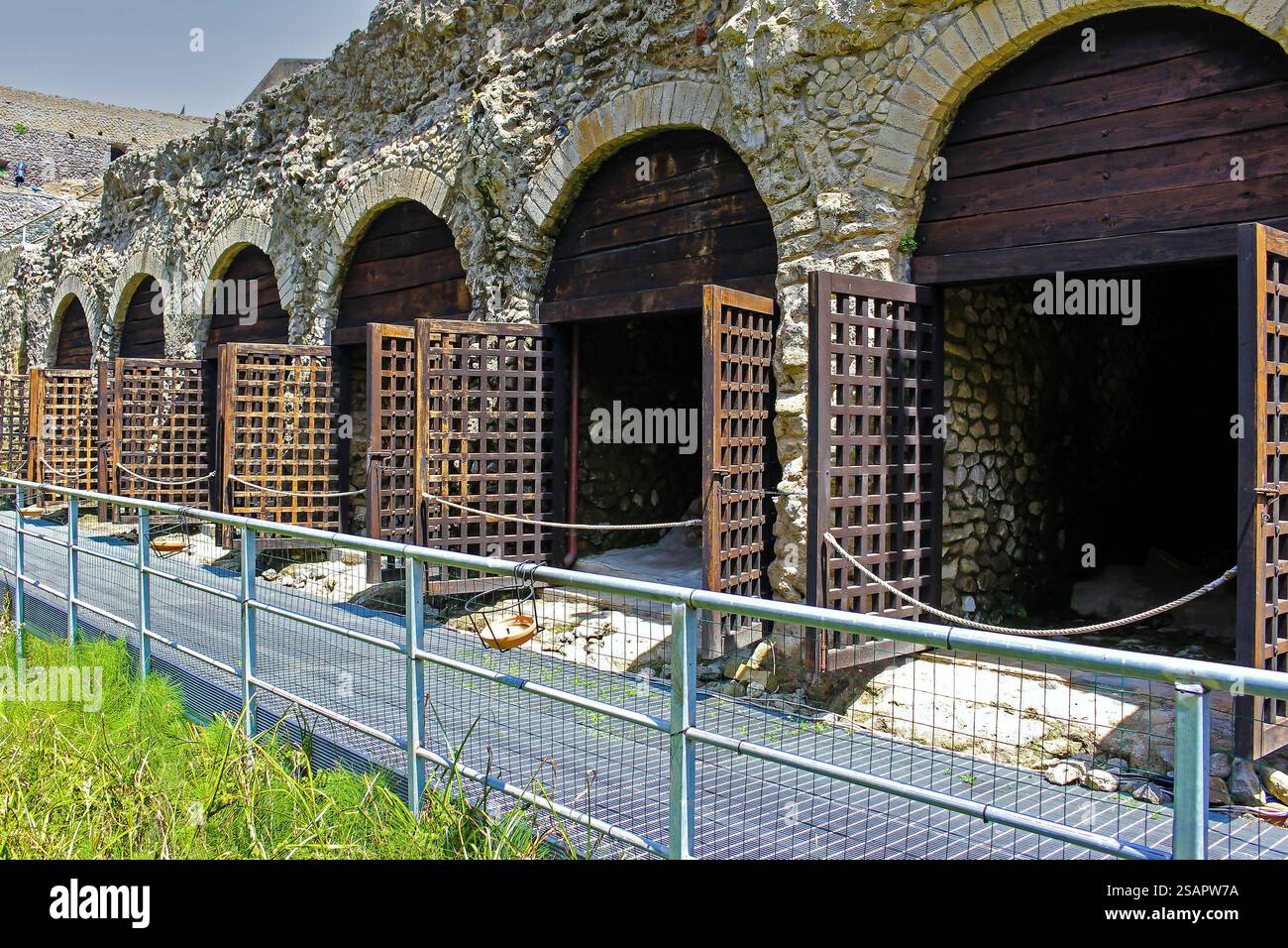 Ancient dark caves with open doors in rocks outside in Napoli ruins ...