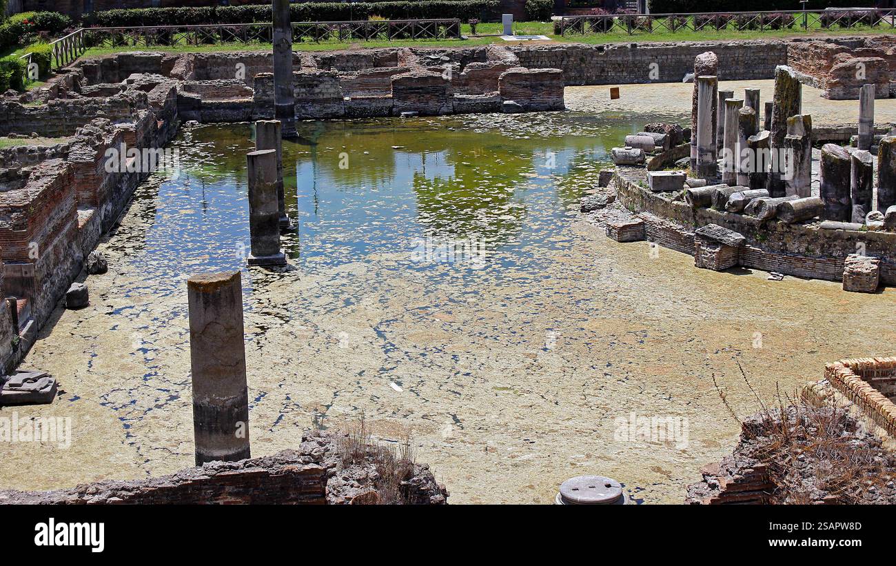 Roman temple in Pozzuoli bay of Naples with columns stand amid the well ...