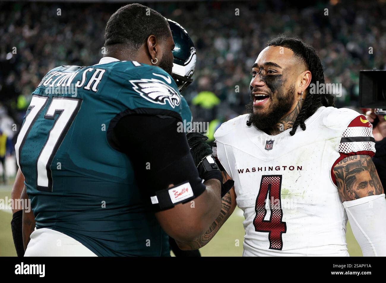 Washington Commanders linebacker Frankie Luvu (4) interacts with ...