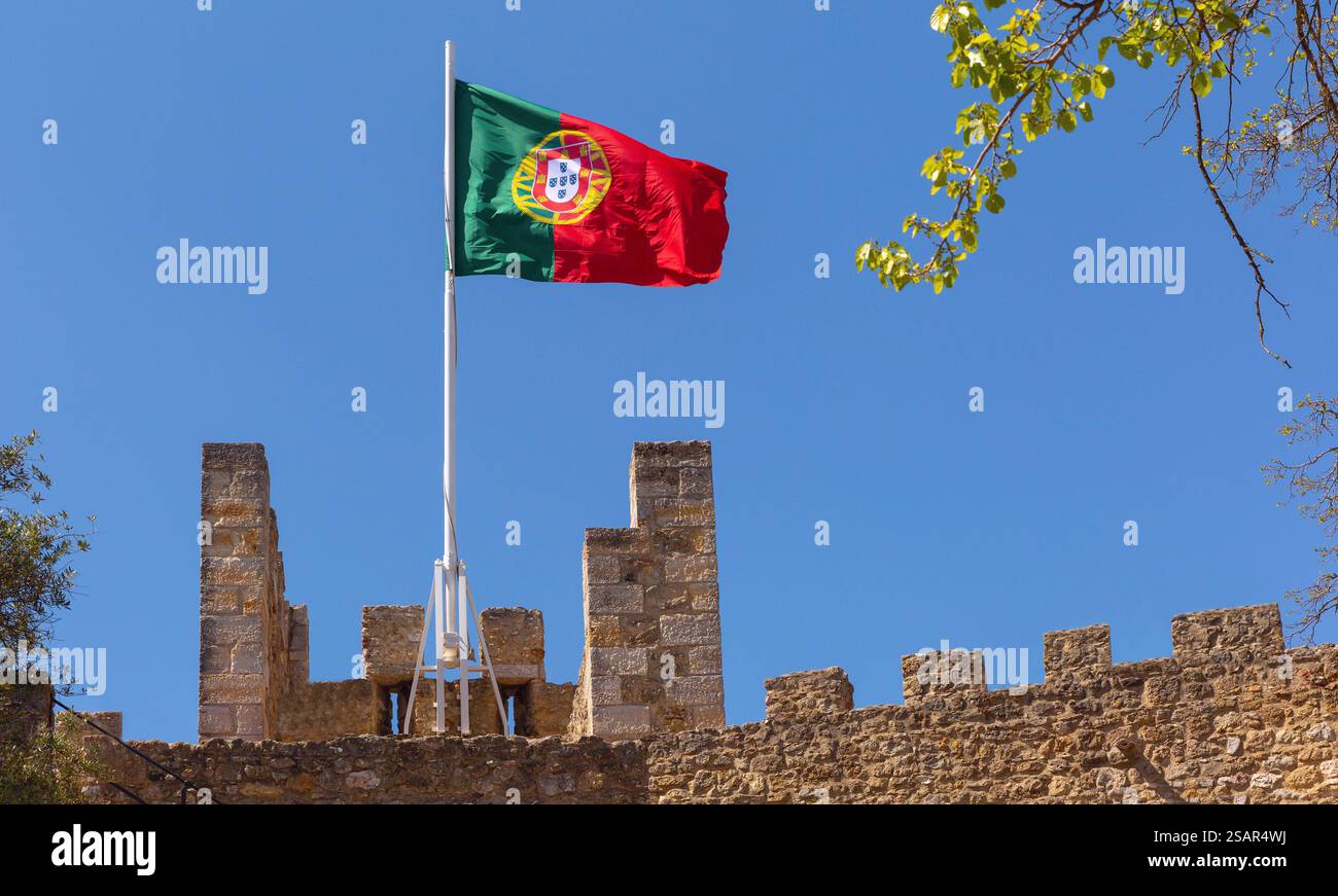 The Portuguese national flag flying atop the medieval walls of Sao ...