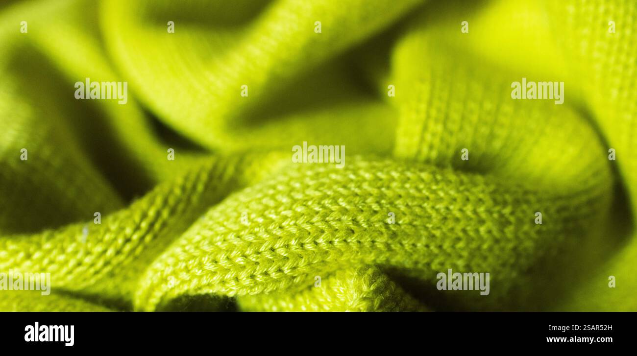 Bright lemon coloured knitted fabric texture with waves and selective ...