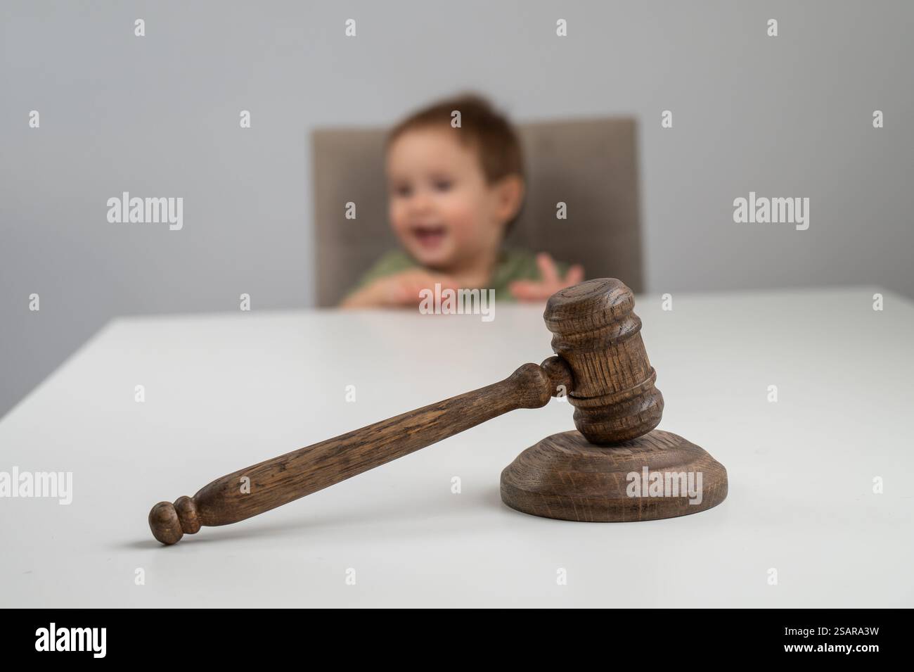 Little boy behind judge's gavel Stock Photo - Alamy