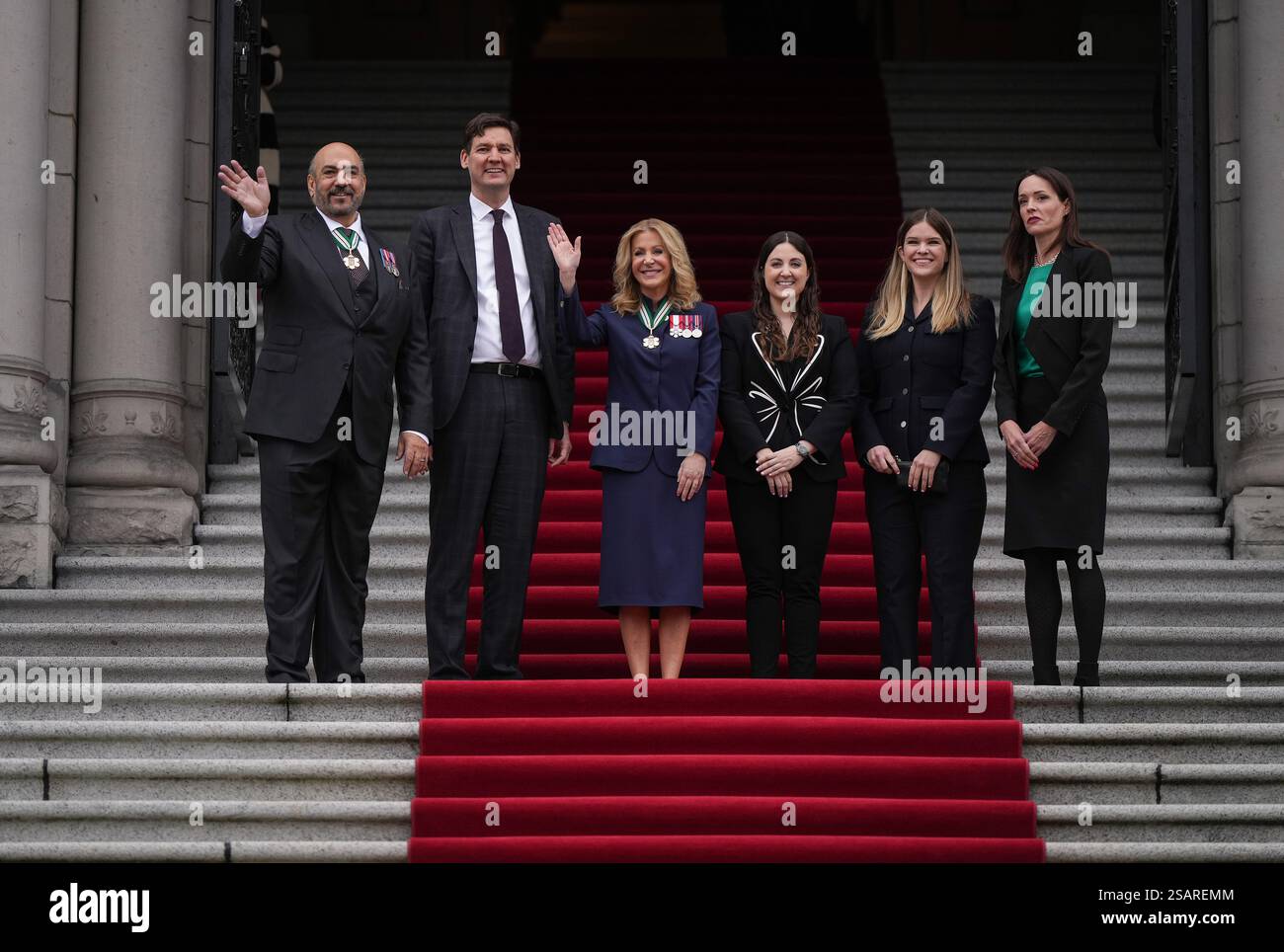 Victoria, Canada. 30th Jan, 2025. Wendy Cocchia, third left, stands on ...