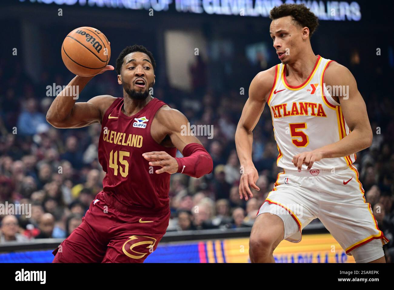 Cleveland Cavaliers guard Donovan Mitchell, left, goes to the basket against Atlanta Hawks guard ...