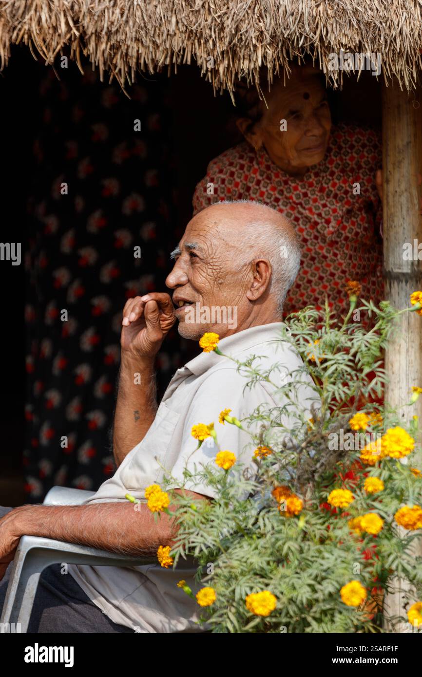 A tribal Taru man and his wife in their village in the Tarai region of ...
