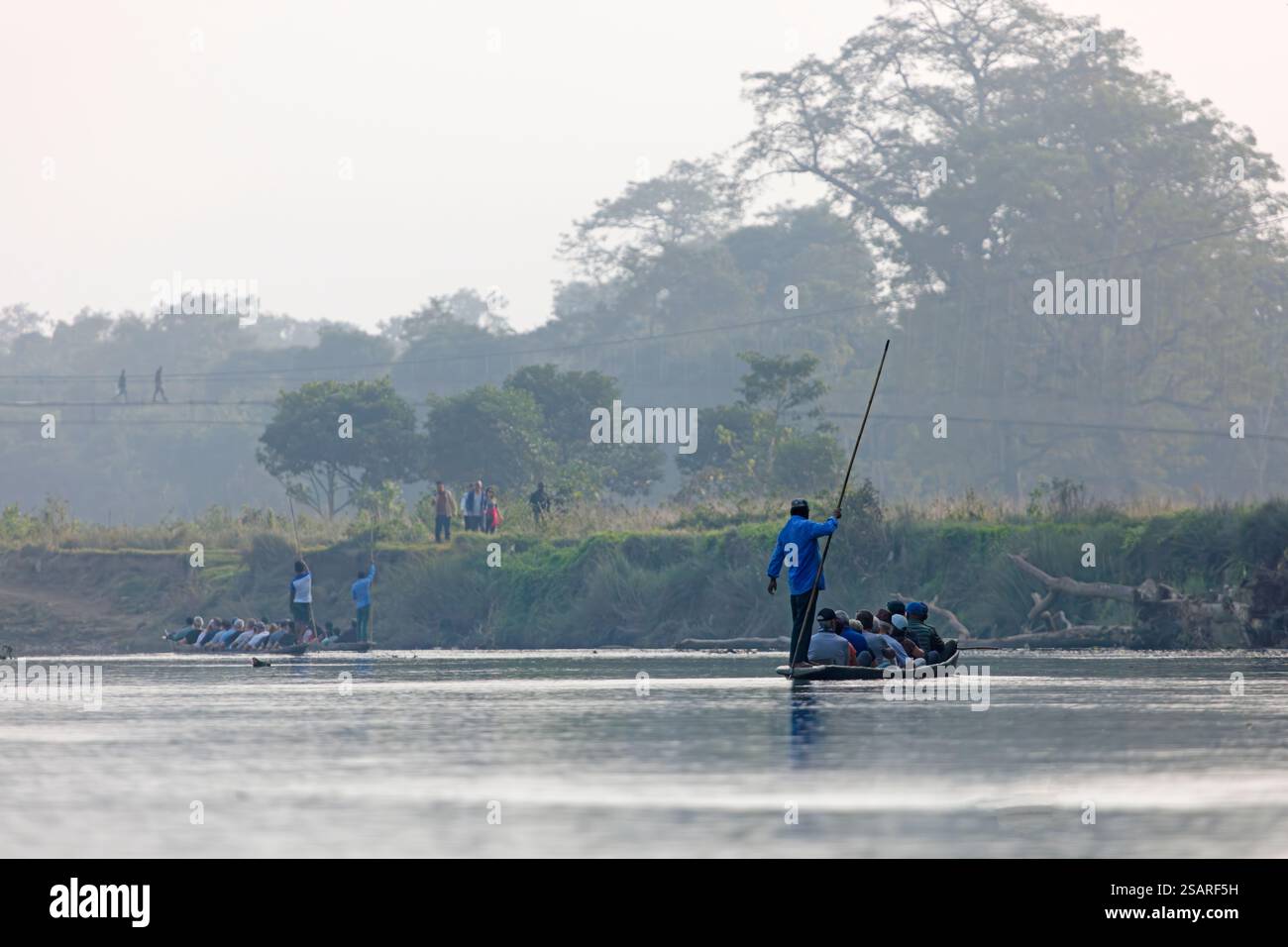 Poled tourist boat in the Narayani River defines the boundary of the ...